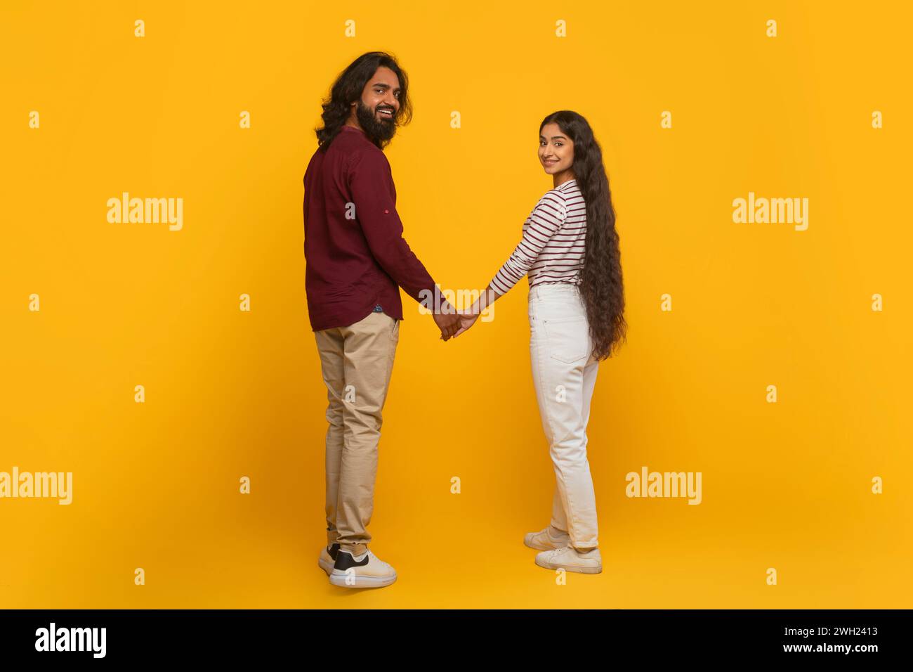 Back view of young indian couple holding hands Stock Photo - Alamy