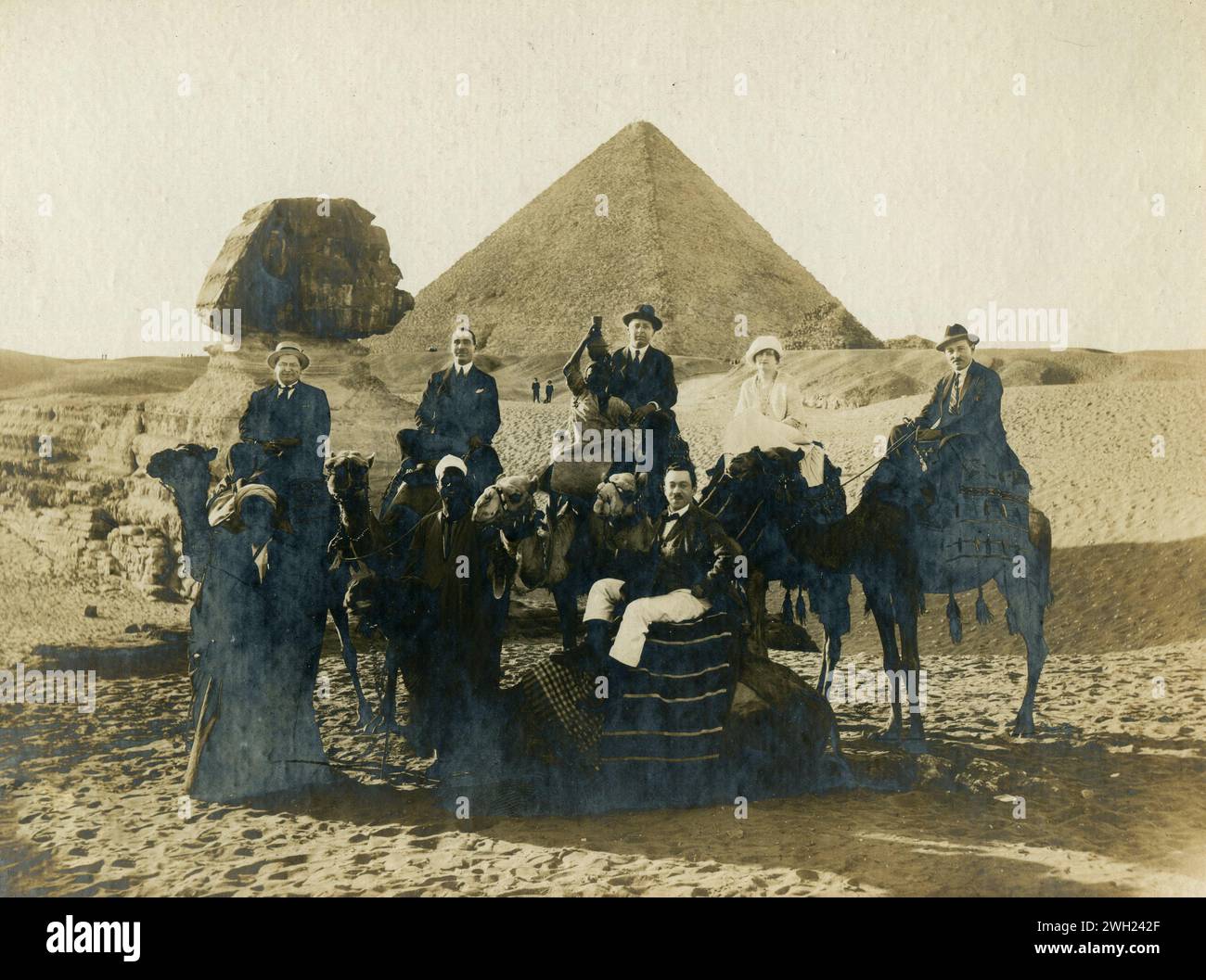 Tourists riding camels at the great pyramid and Sphinx, Giza, Egypt ...