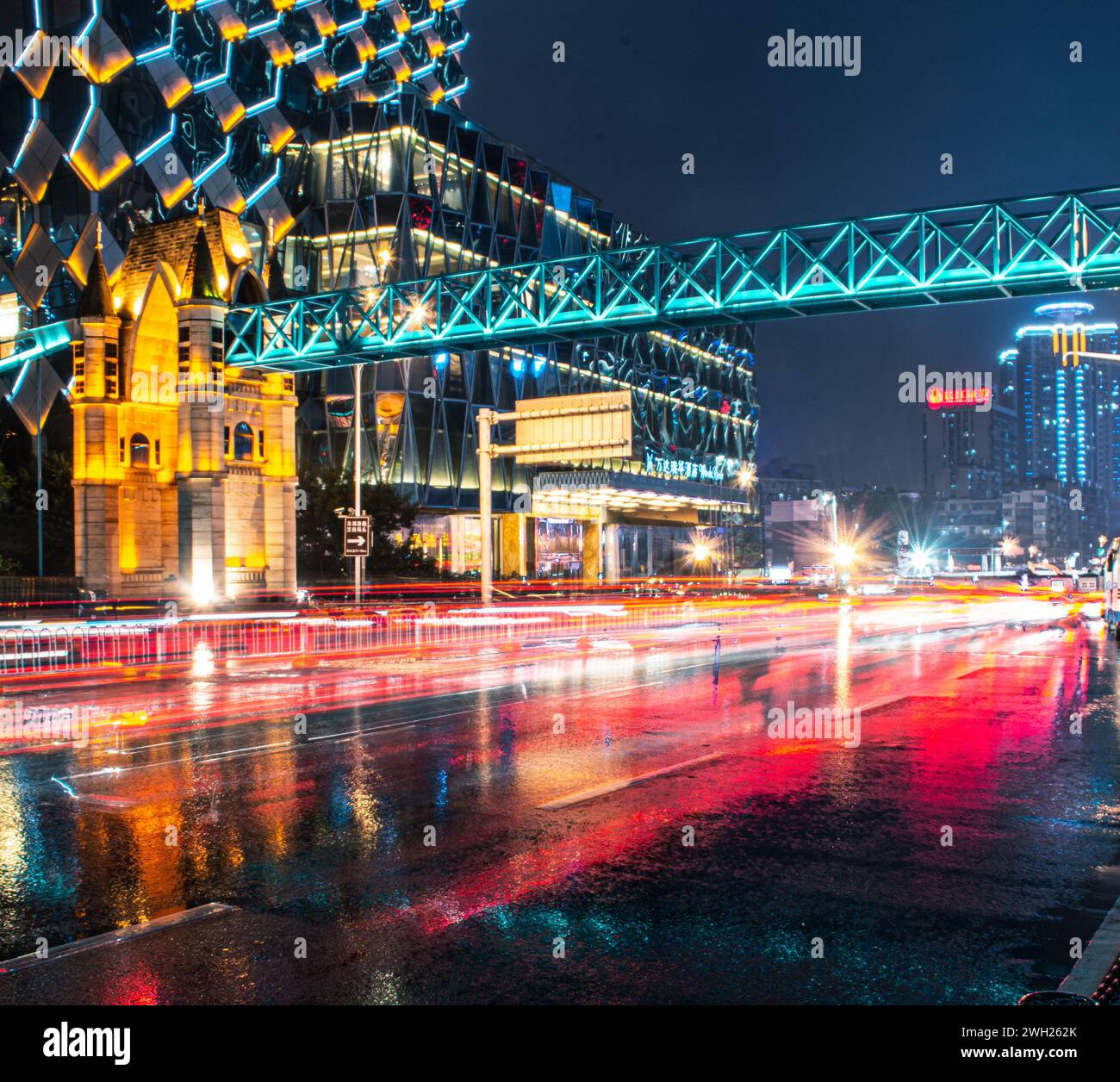 The commercial district road surface illuminated by brilliant neon ...