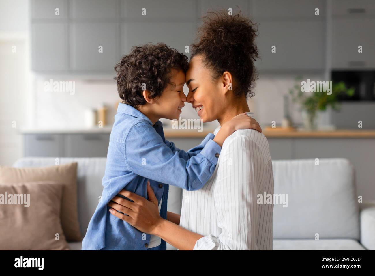 Loving mother and son sharing tender nose-to-nose embrace, side view ...