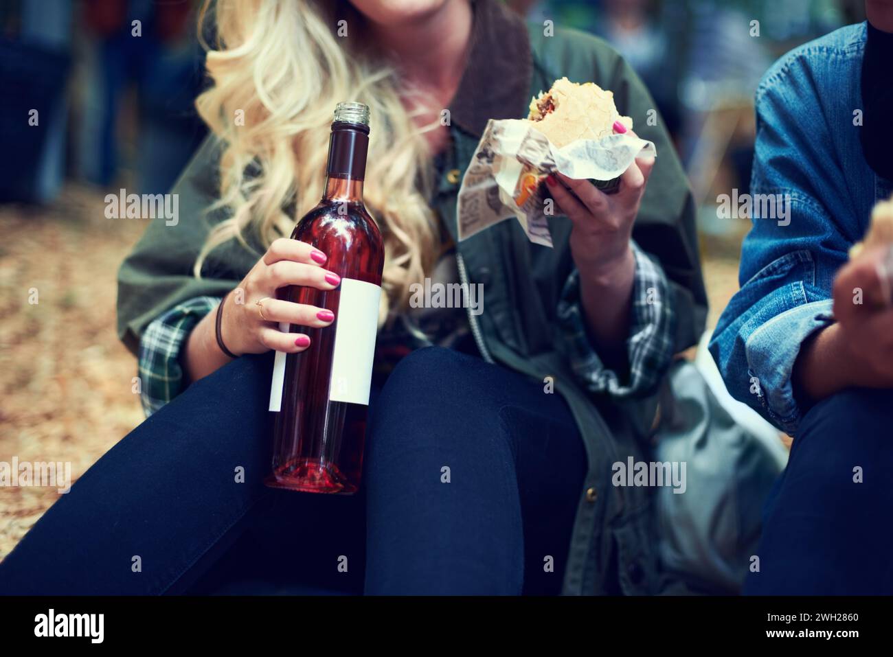 Snack, woman and music festival with friends, beer and happiness with ...