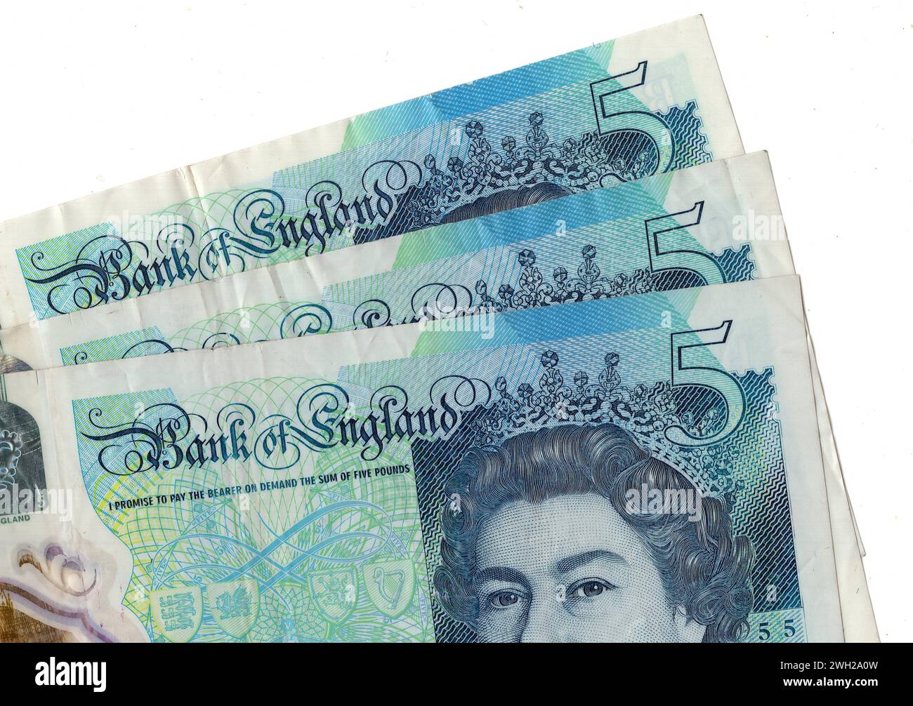 Five pound notes featuring a portrait of Queen Elizabeth II from the ...