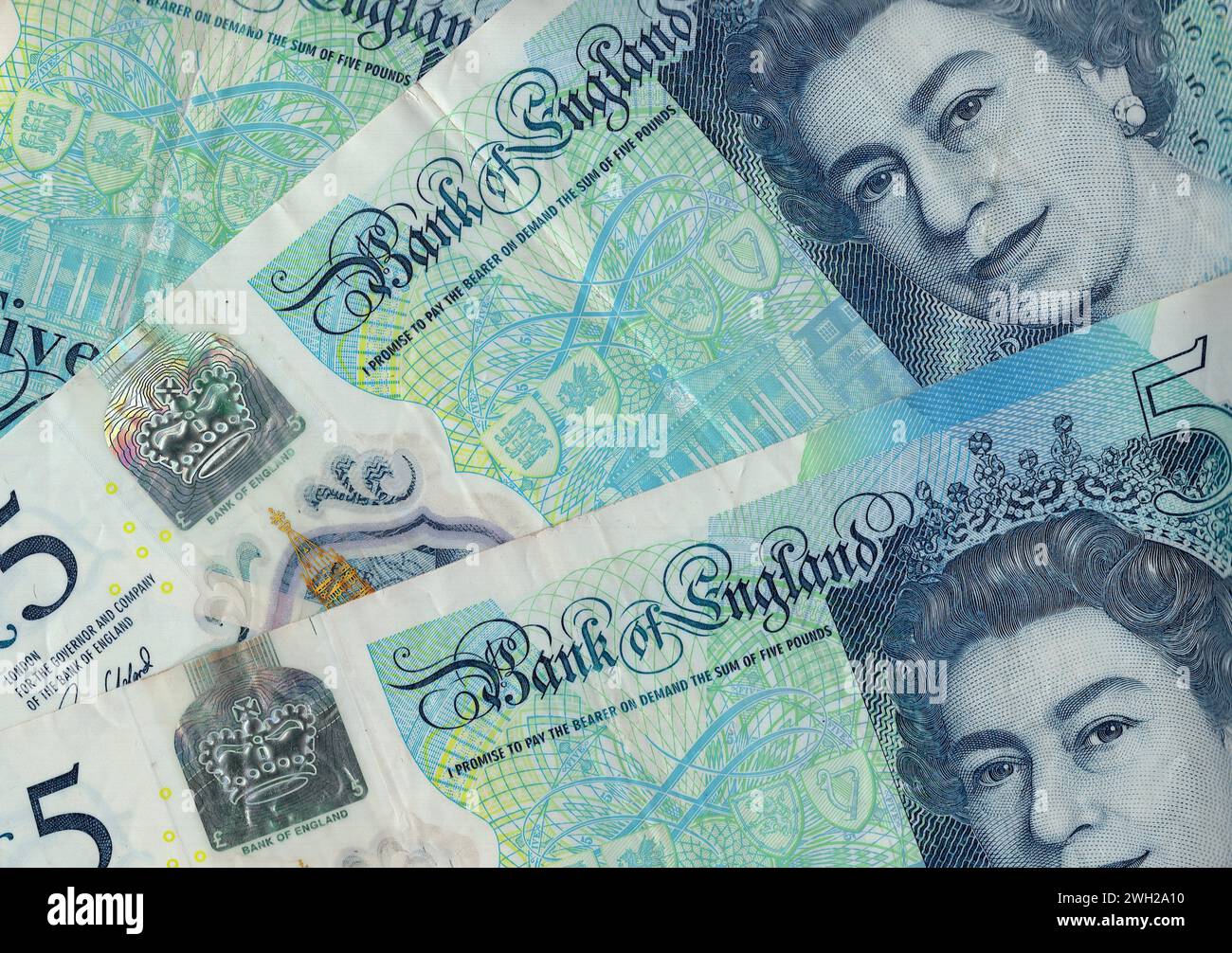 Five pound notes featuring a portrait of Queen Elizabeth II from the ...