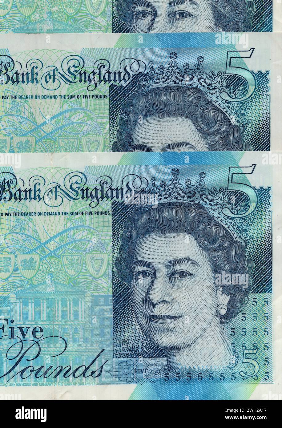Five pound notes featuring a portrait of Queen Elizabeth II from the ...