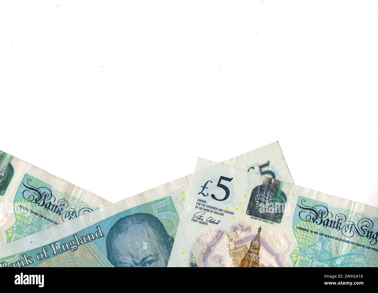 Five pound notes from the United Kingdom isolated on a white background ...