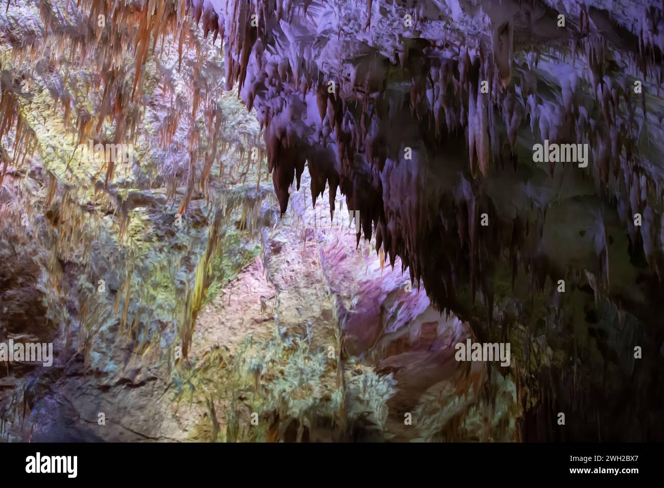Karst cave, amazing view of stalactites and stalagnites in colorful ...