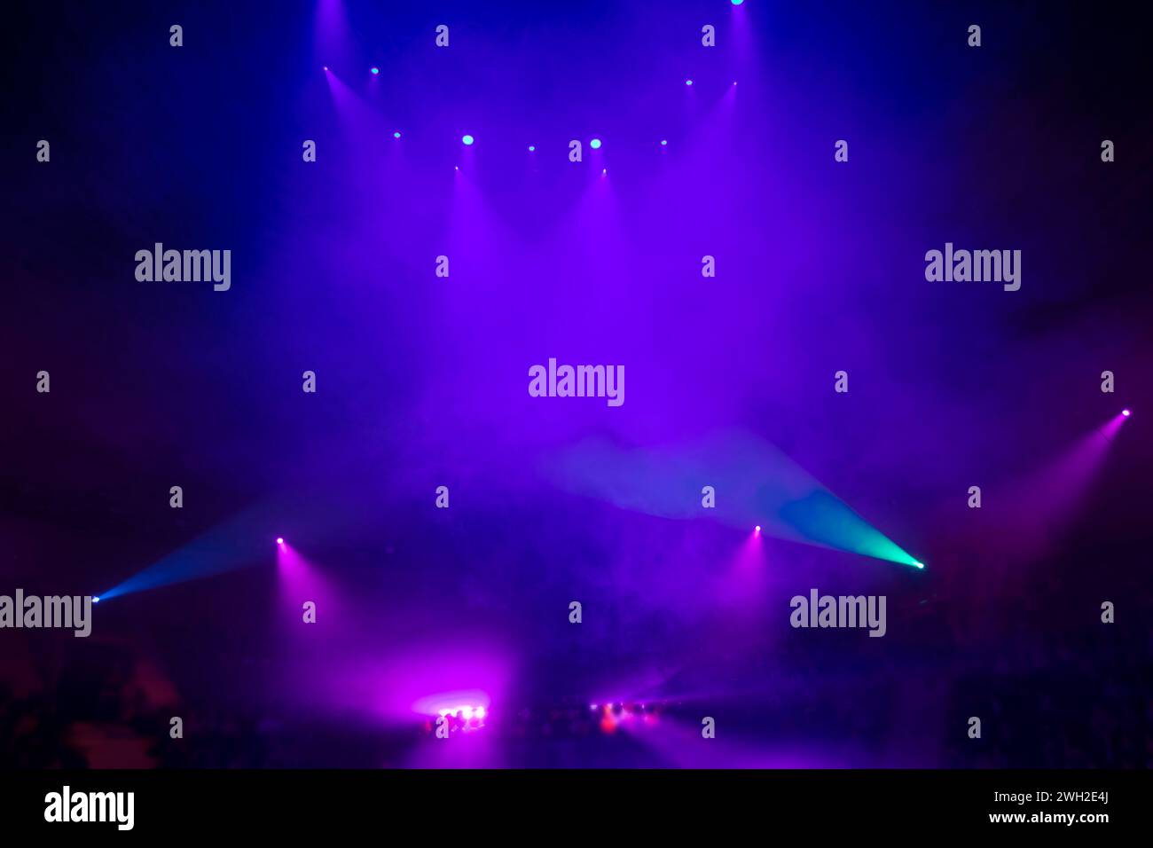 Bright festive multi-colored stage lighting with optical flare and rays ...