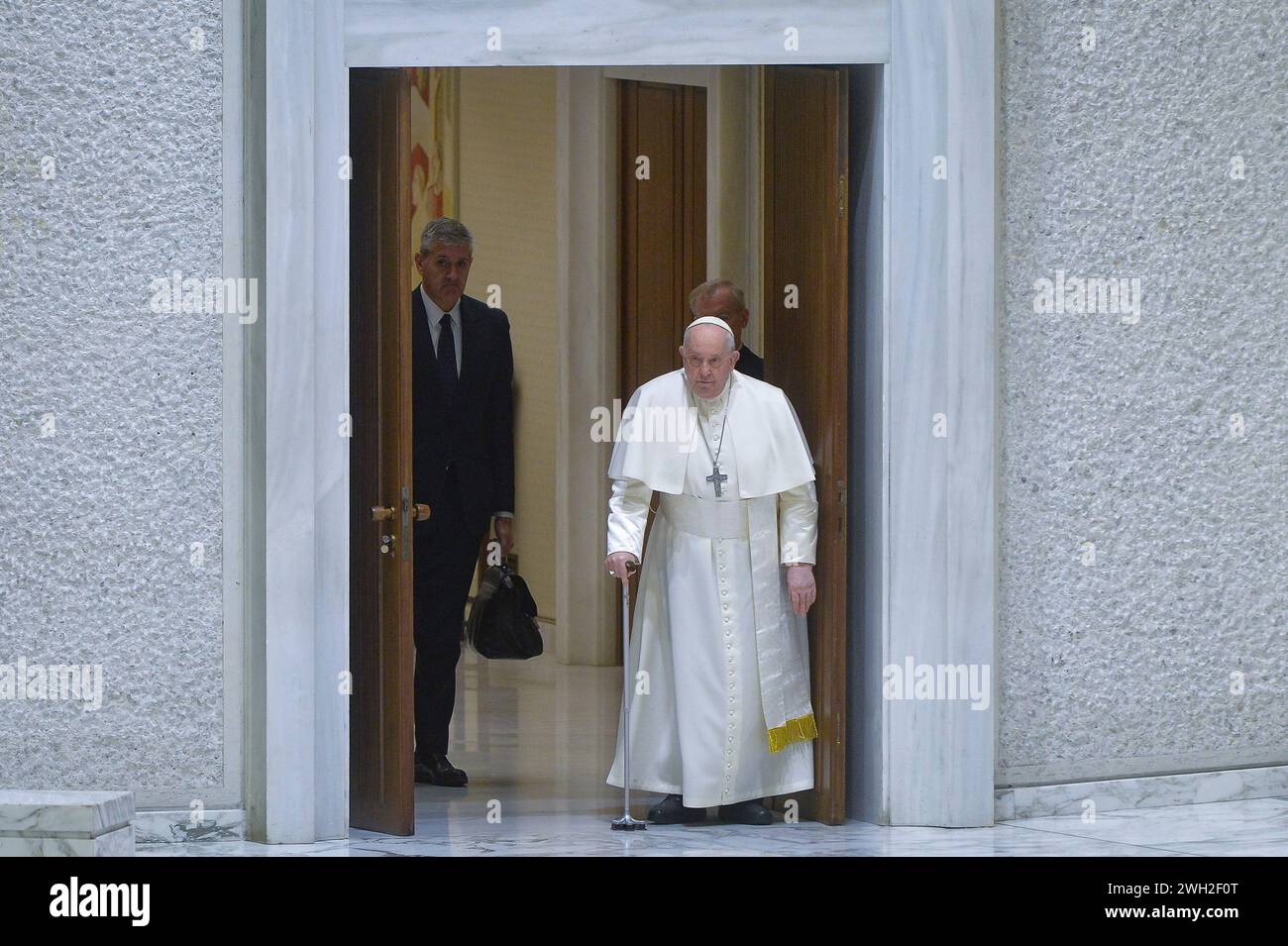 Italy, Rome, February 7, 2024 : Pope Francis walks with the help of a ...