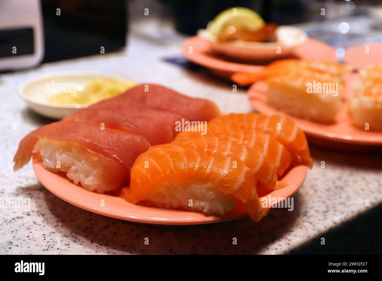 Sushi plate with tuna and salmon nigiri. Japanese conveyour belt sushi ...