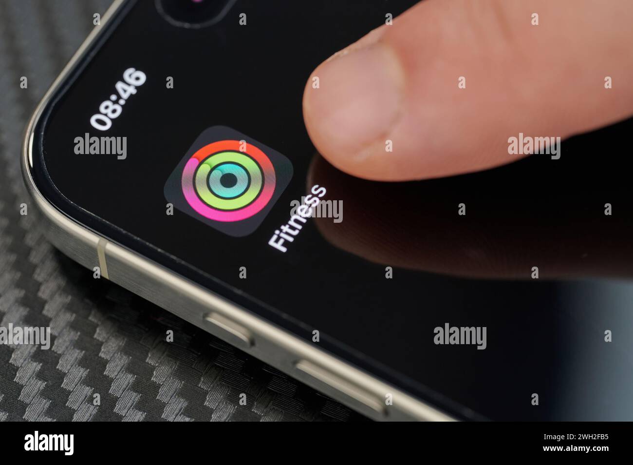 New York, USA - January 24, 2024: Touching top open Fitness app icon ...