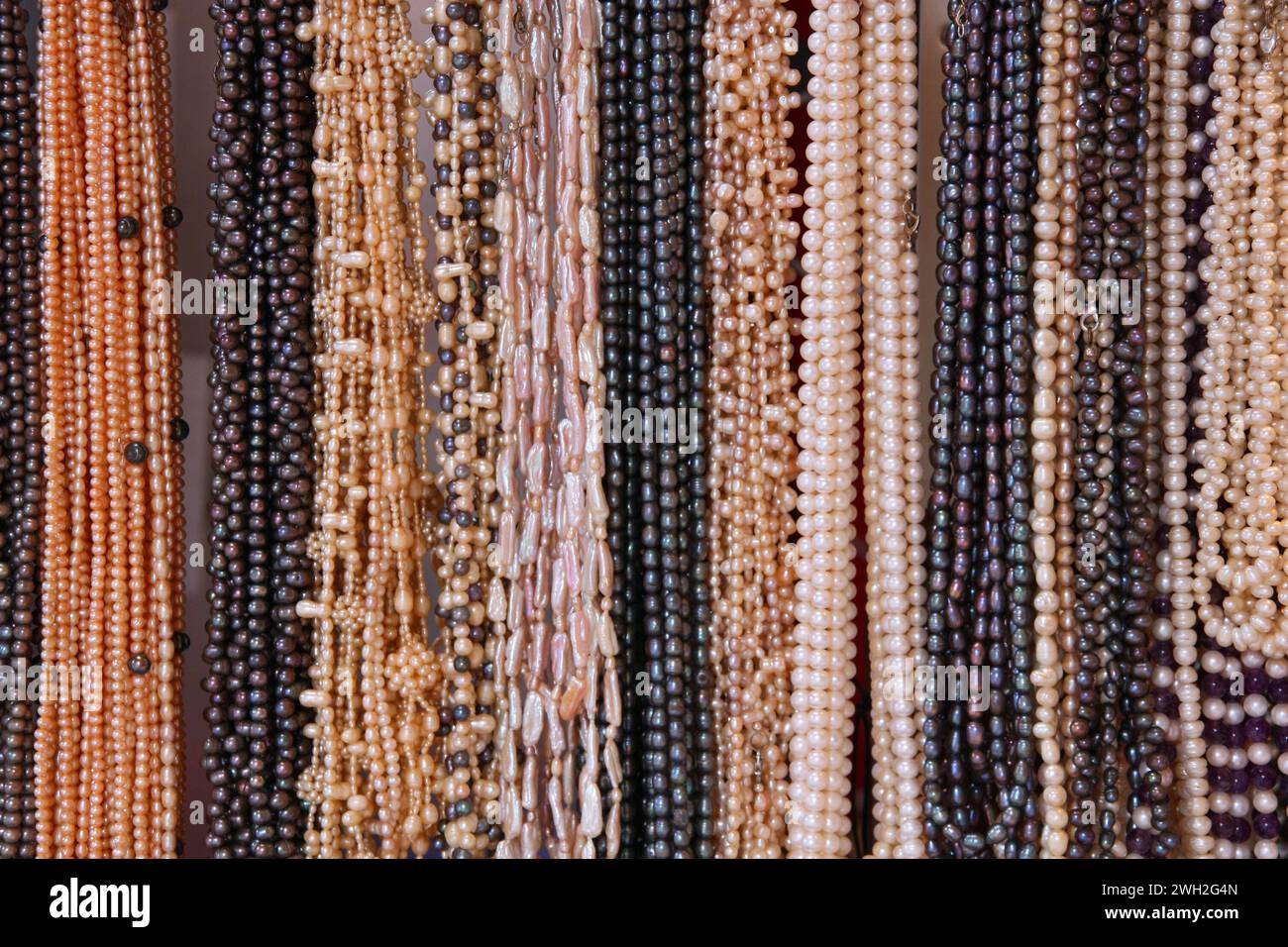 Faux pearl necklaces on display in a jewelry store window in Singapore ...