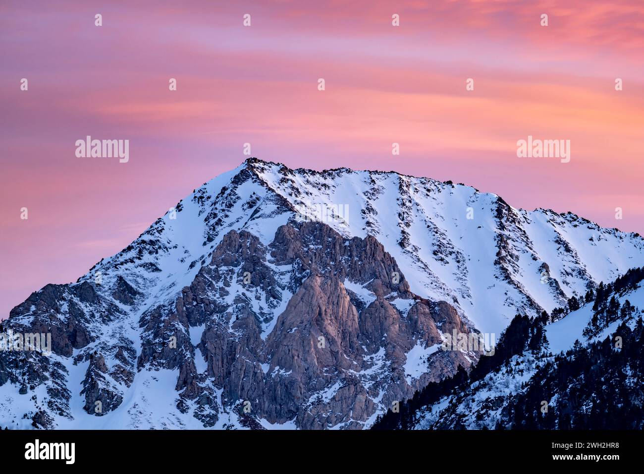 Snowy Roc Blanc peak in Ariège Pyrenees, glowing under sunset's orange ...