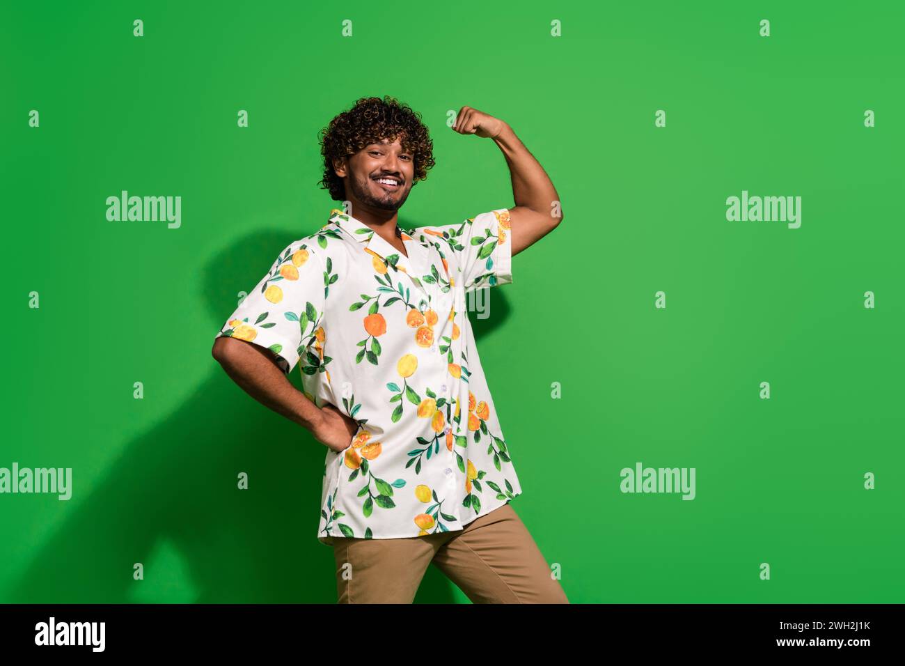Photo portrait of attractive young man show muscles fist dressed ...