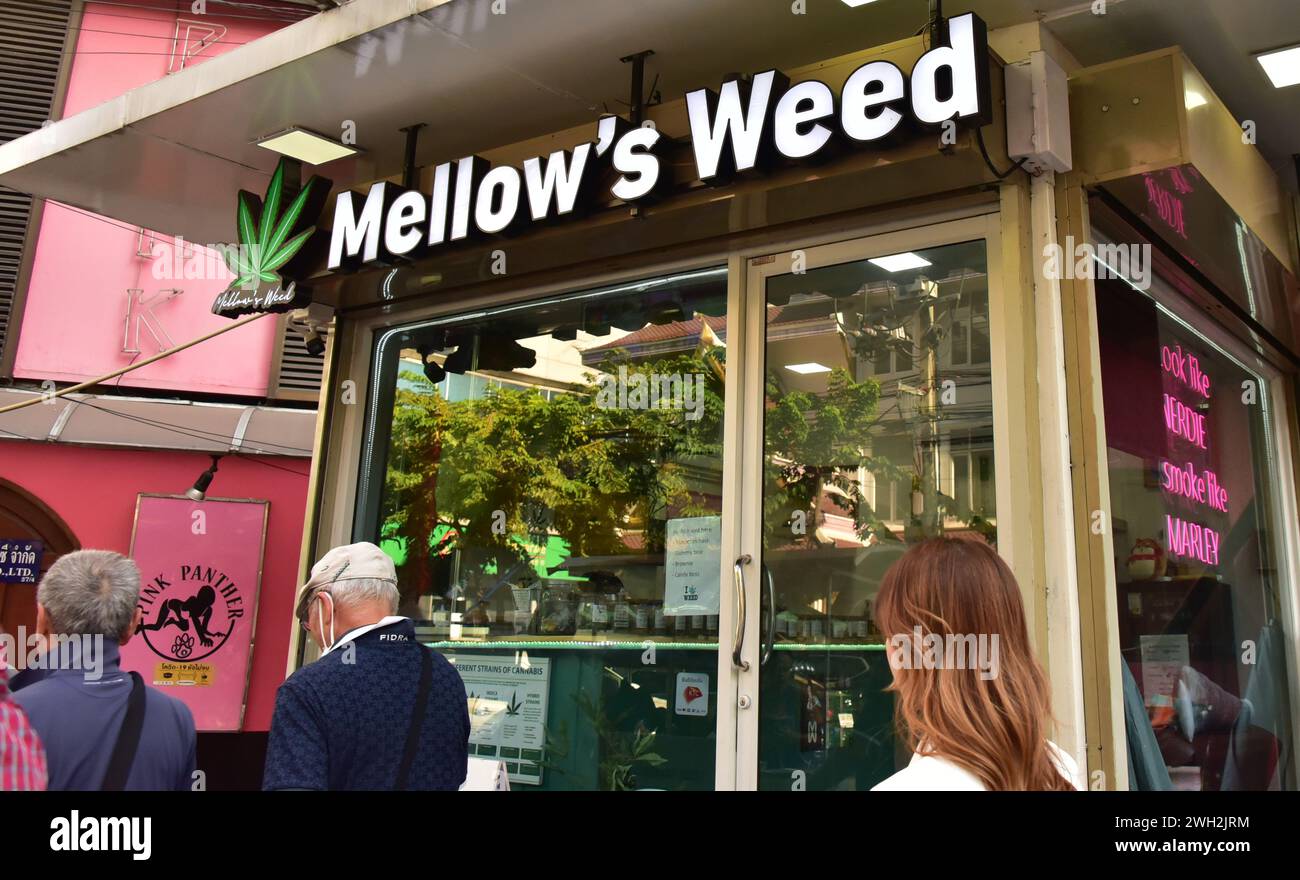 People walk pat Mellow's Weed cannabis shop on Surawong Road, Bangkok ...
