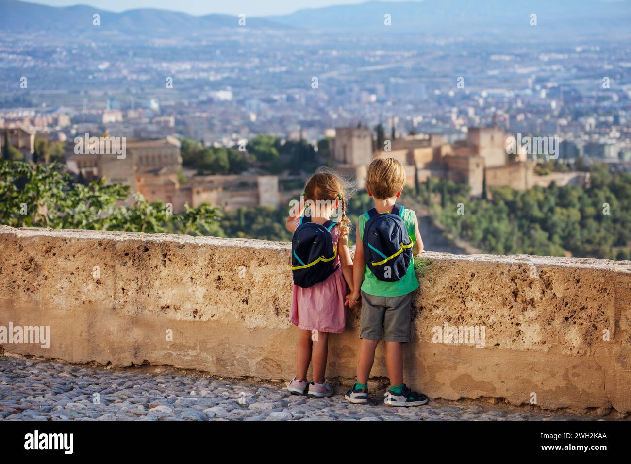 Cute boy and girl overlook magnificent castle Alhambra, Spain Stock ...