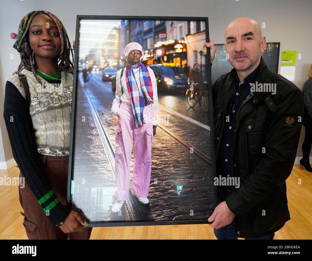 Janet Idowu, who lives with sickle cell disease, next to her portrait ...