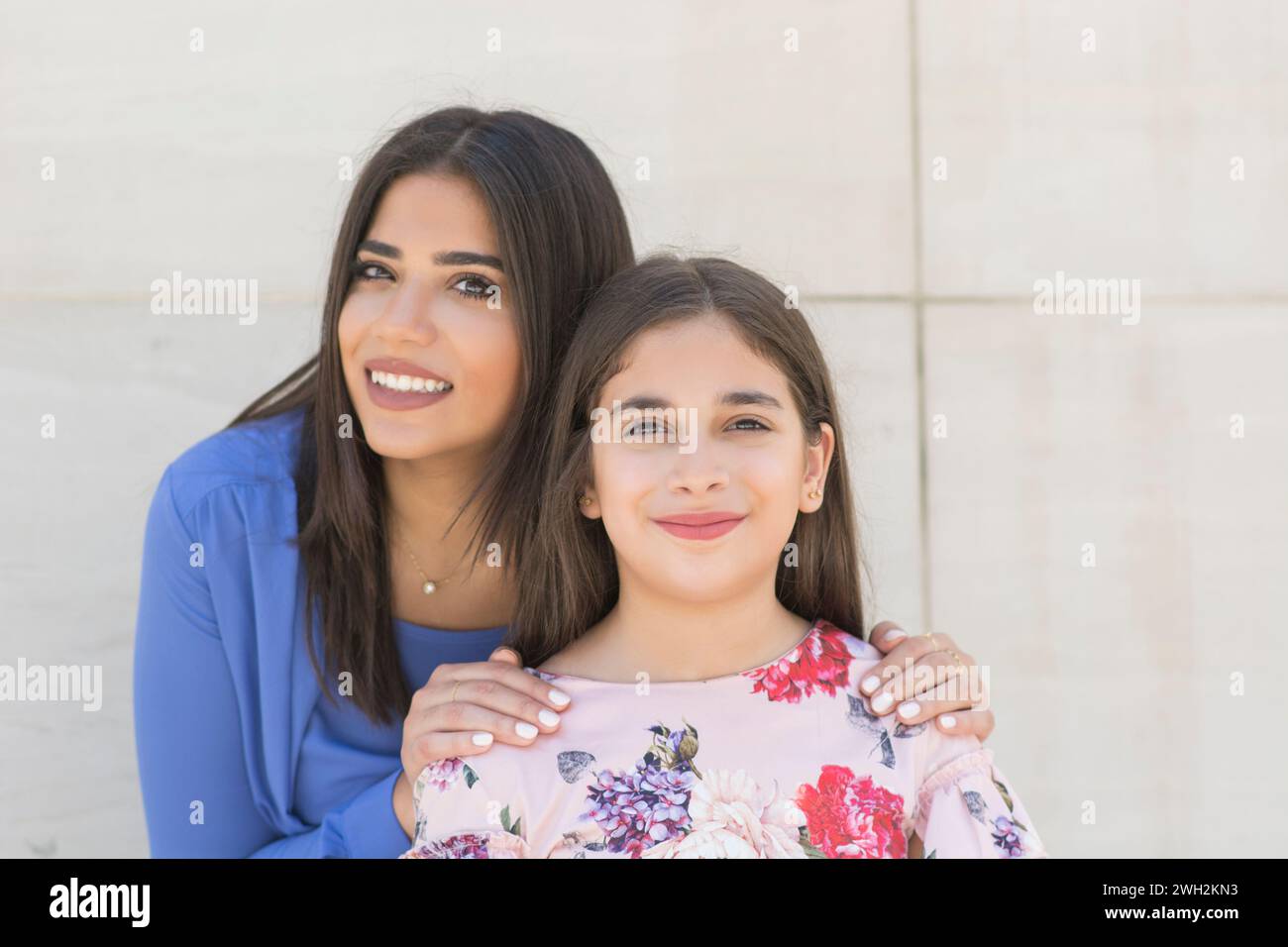 Two happy sisters looking at camera smiling outdoors Stock Photo - Alamy