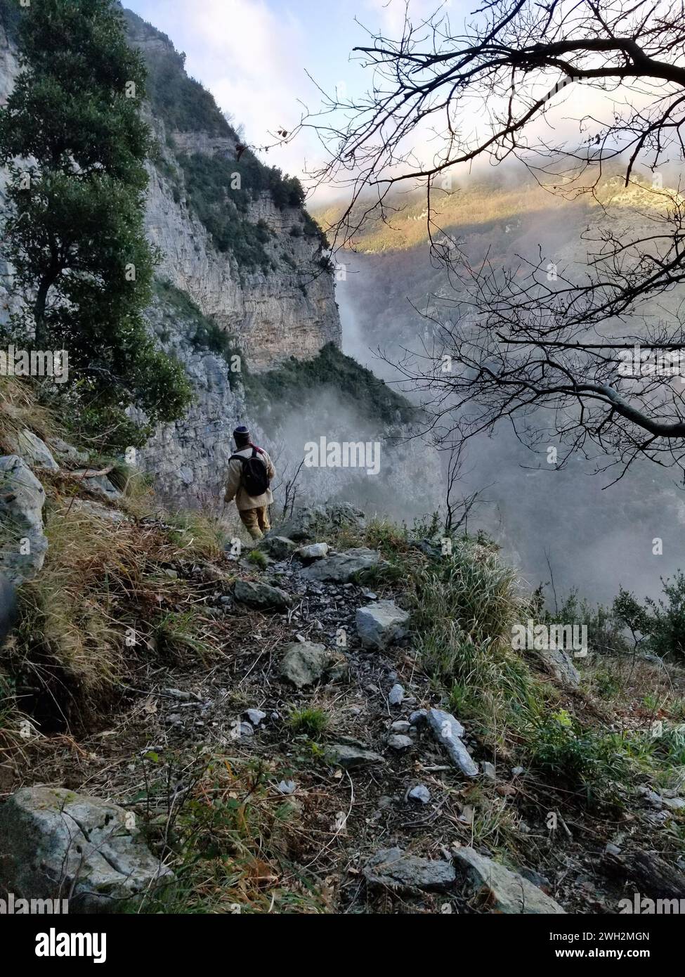 A hiker standing on the cliffside. A walking path between Agerola and ...