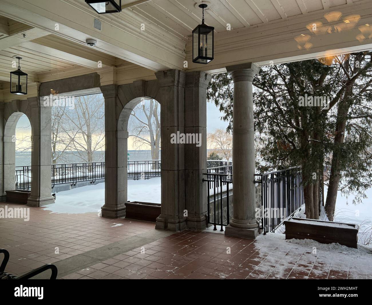 A view from inside the home overlooking a deck with arched doorways and ...