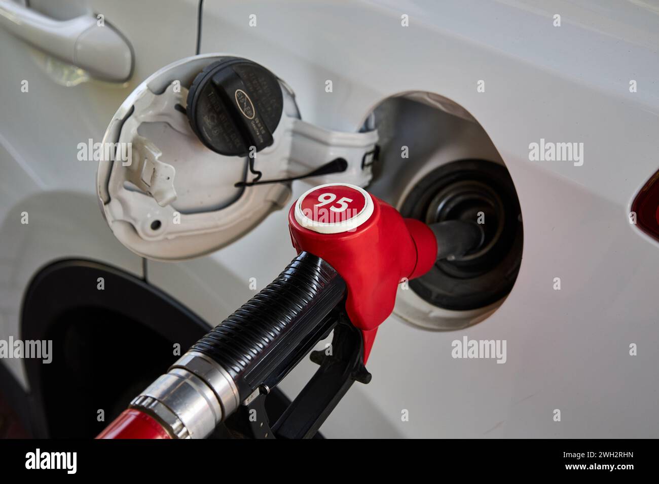 Car refueling process. Gasoline dispenser, Red fuel pump nozzle unit ...