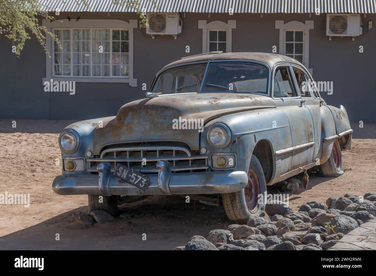 vintage 40's car worn down by rust in exibition at fuel station in ...
