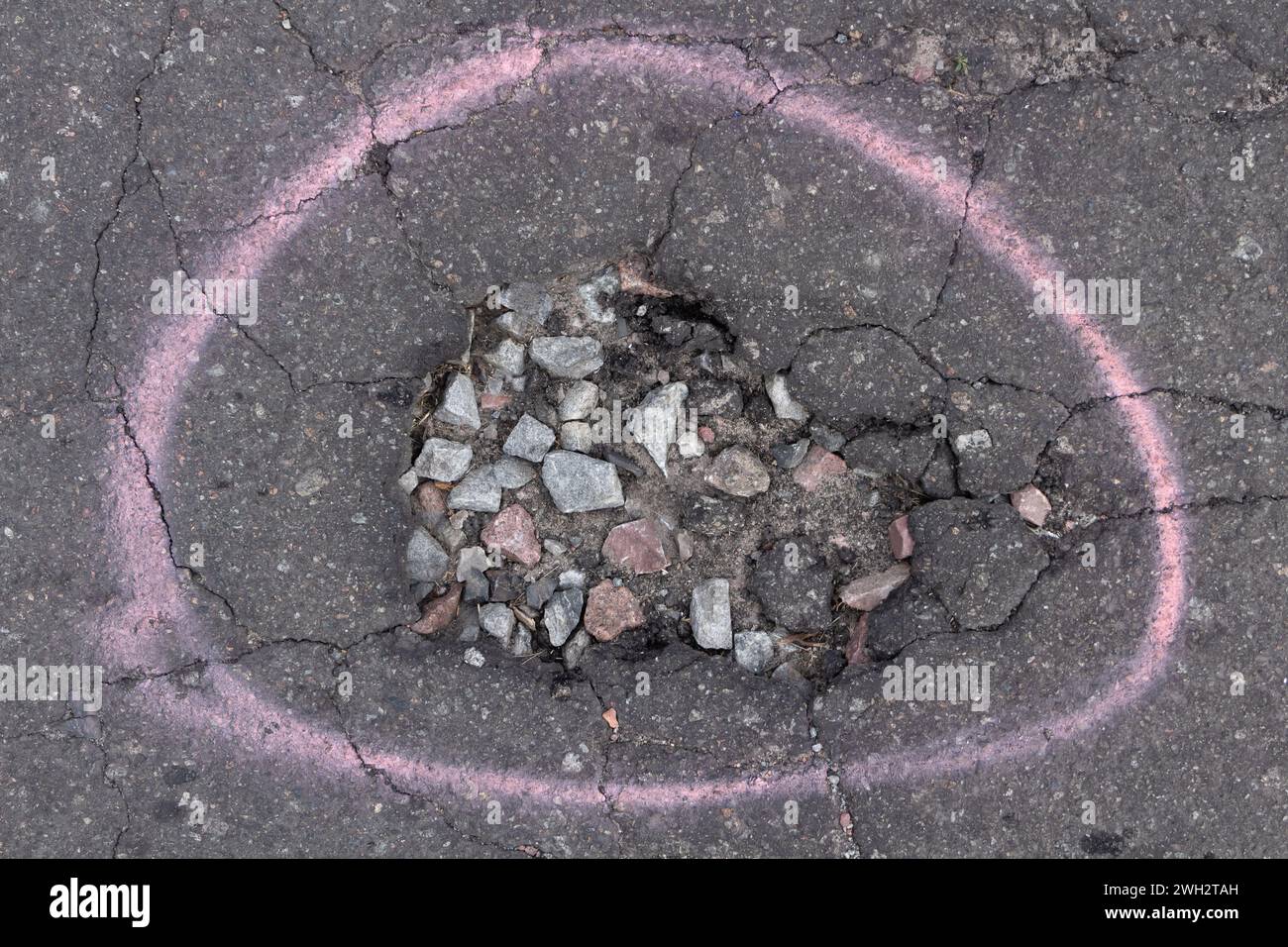 Deep pit on the road. Poor condition of asphalt pavement on the road ...