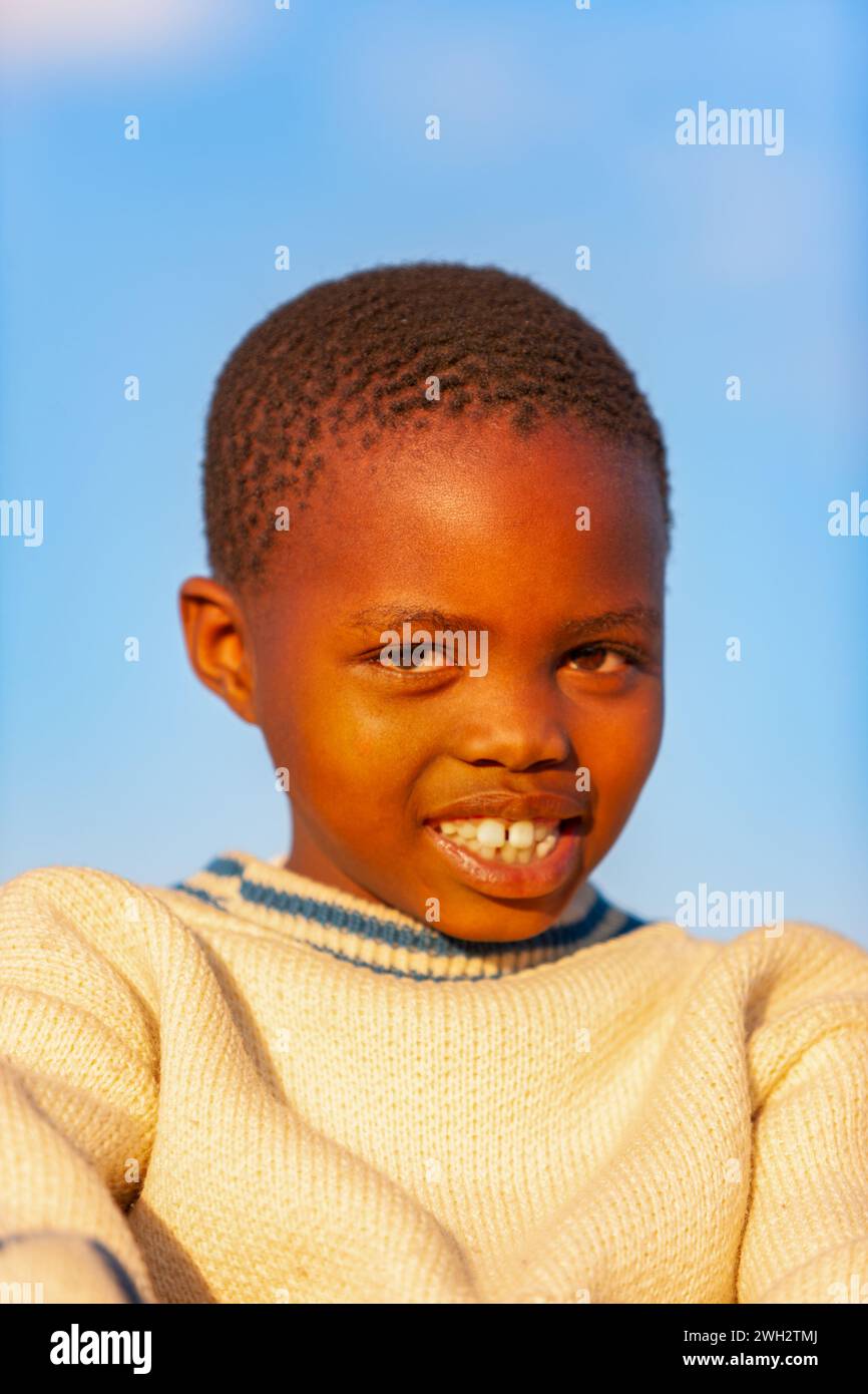 village african child standing outdoors against the blue sky Stock ...