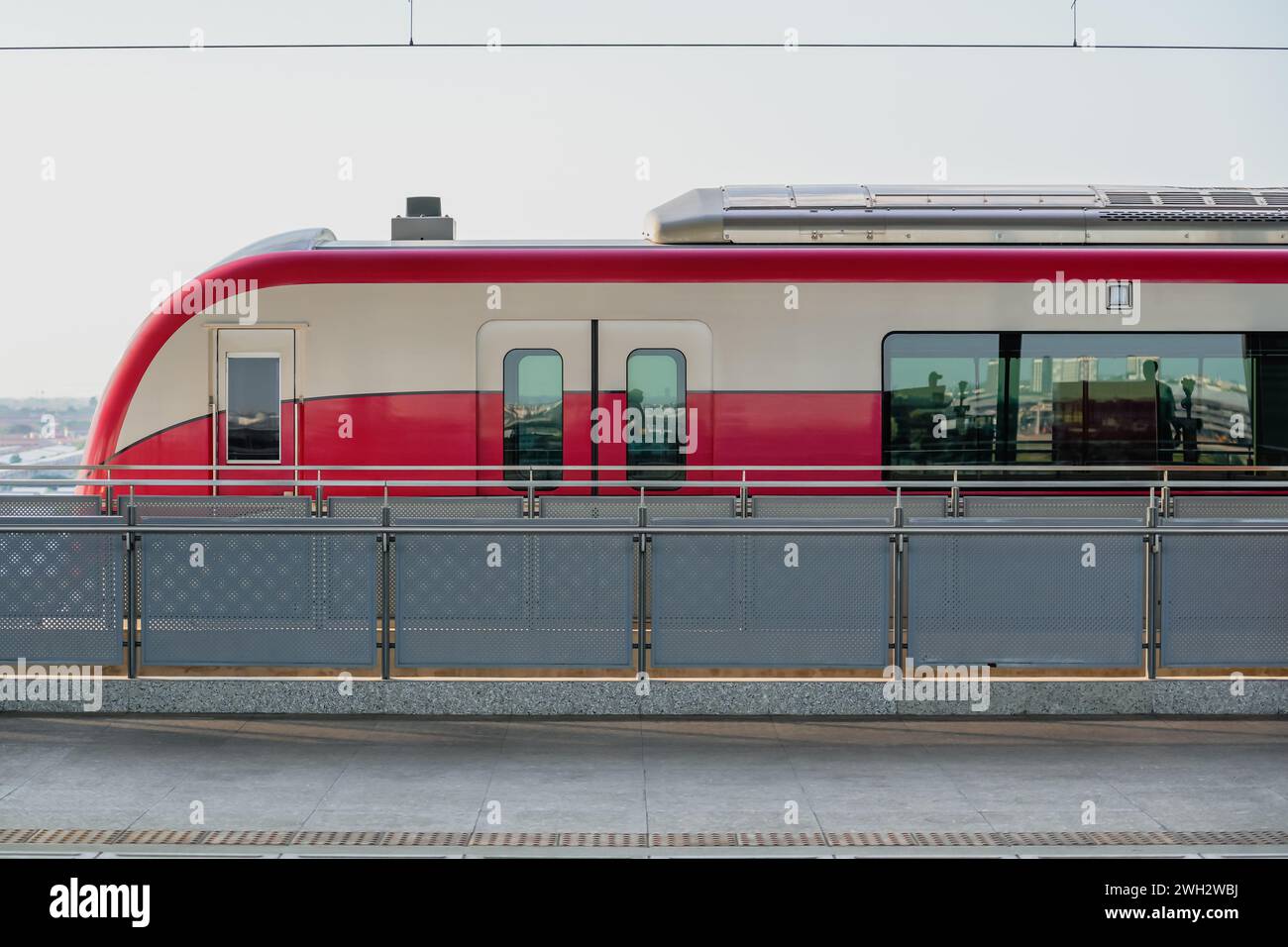 Head locomotive side view of the station platform and commuter train in ...