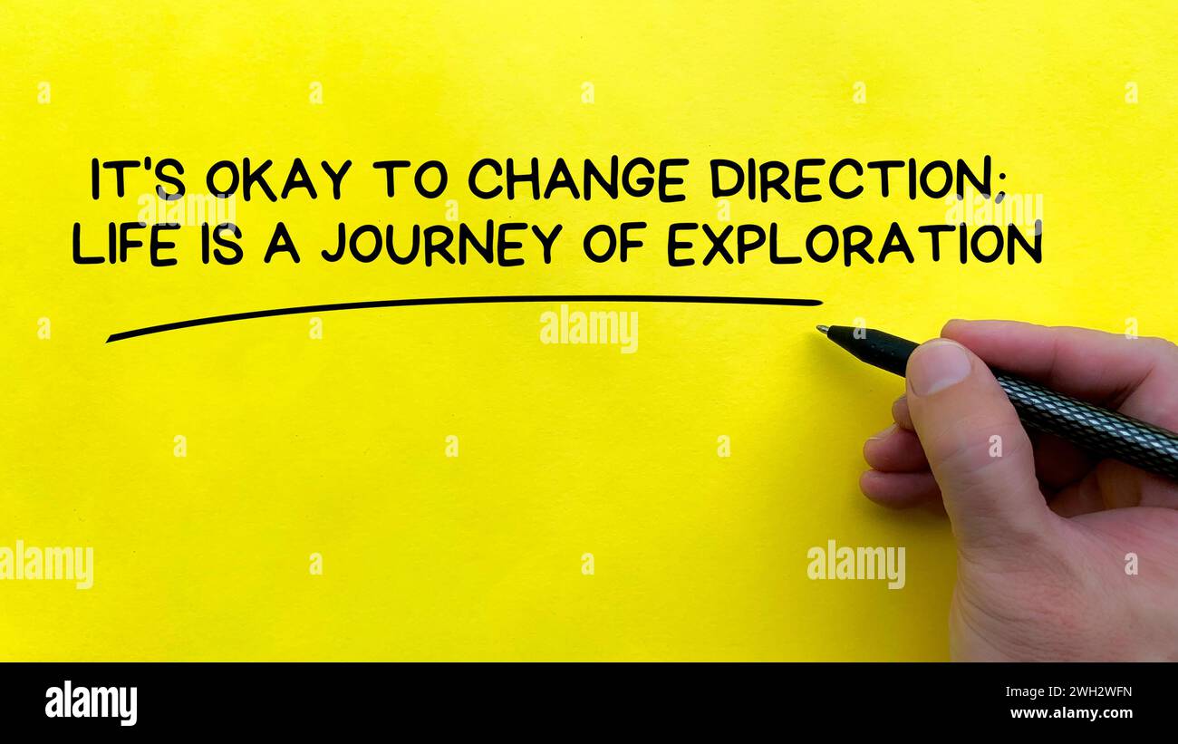 Hand writing It is okay to change direction affirmation on yellow cover ...