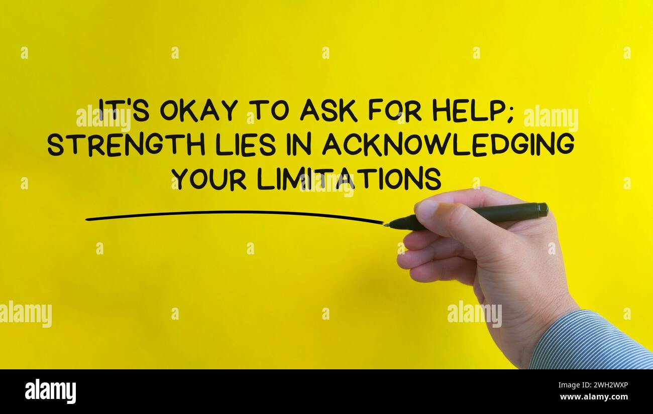 Hand writing It is okay to for help affirmation on yellow cover ...