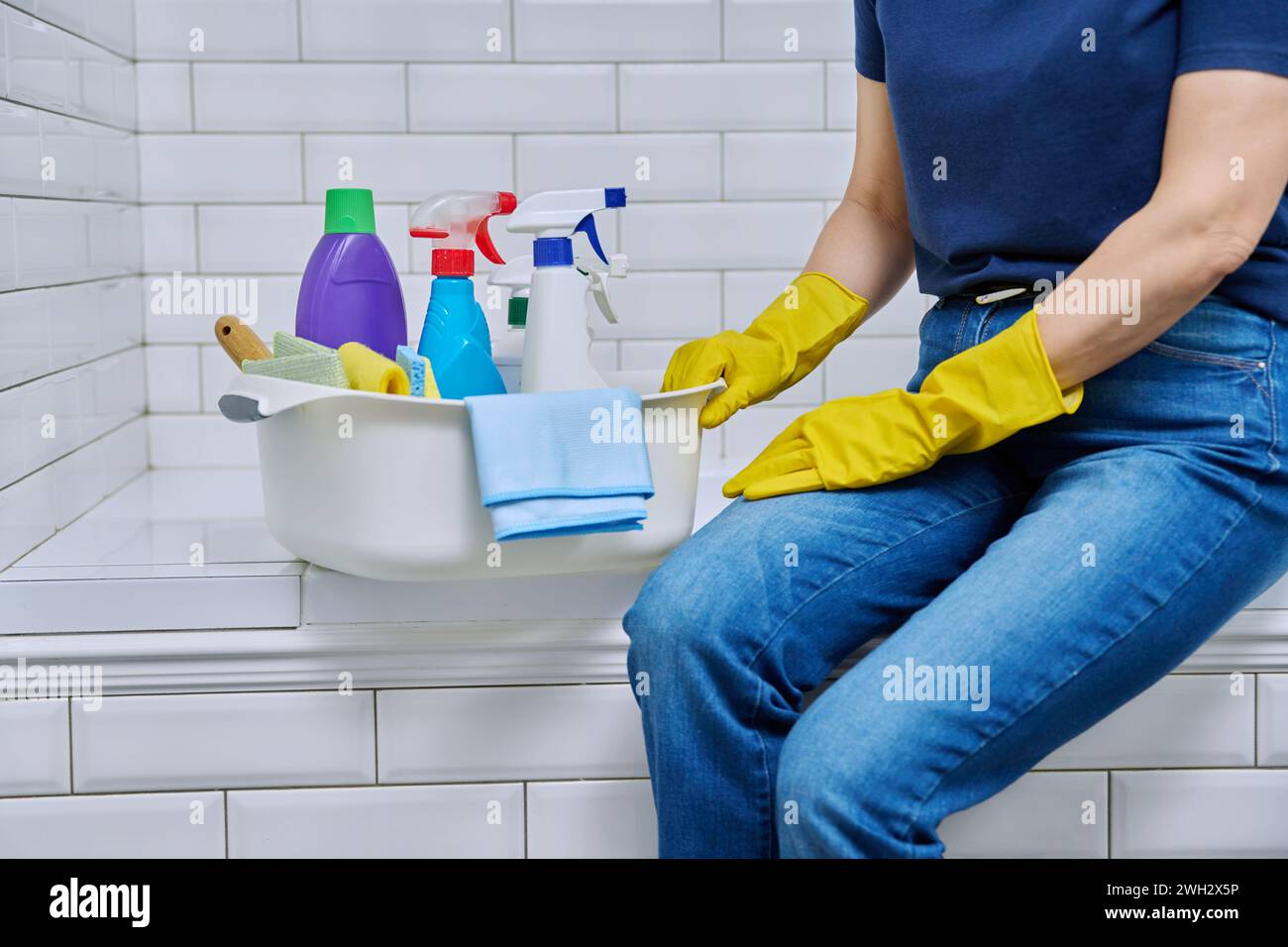 House cleaning concept, basin with cleaning products and hands in ...