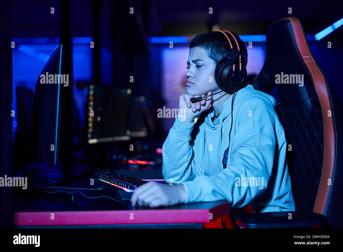 sad short haired woman looking at computer monitor and puffing cheeks ...