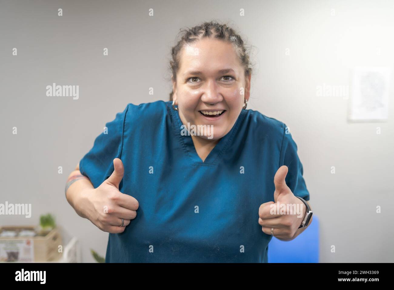 Funny positive woman displaying thumbs up sign as approval, agreement ...