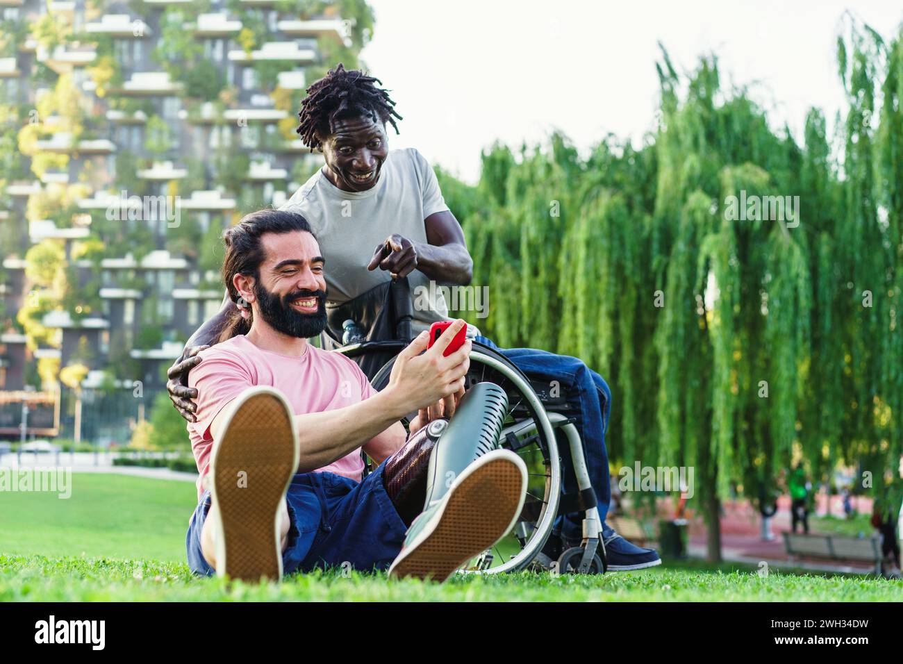 Joyful friends, one with a prosthetic leg and the other in a wheelchair ...