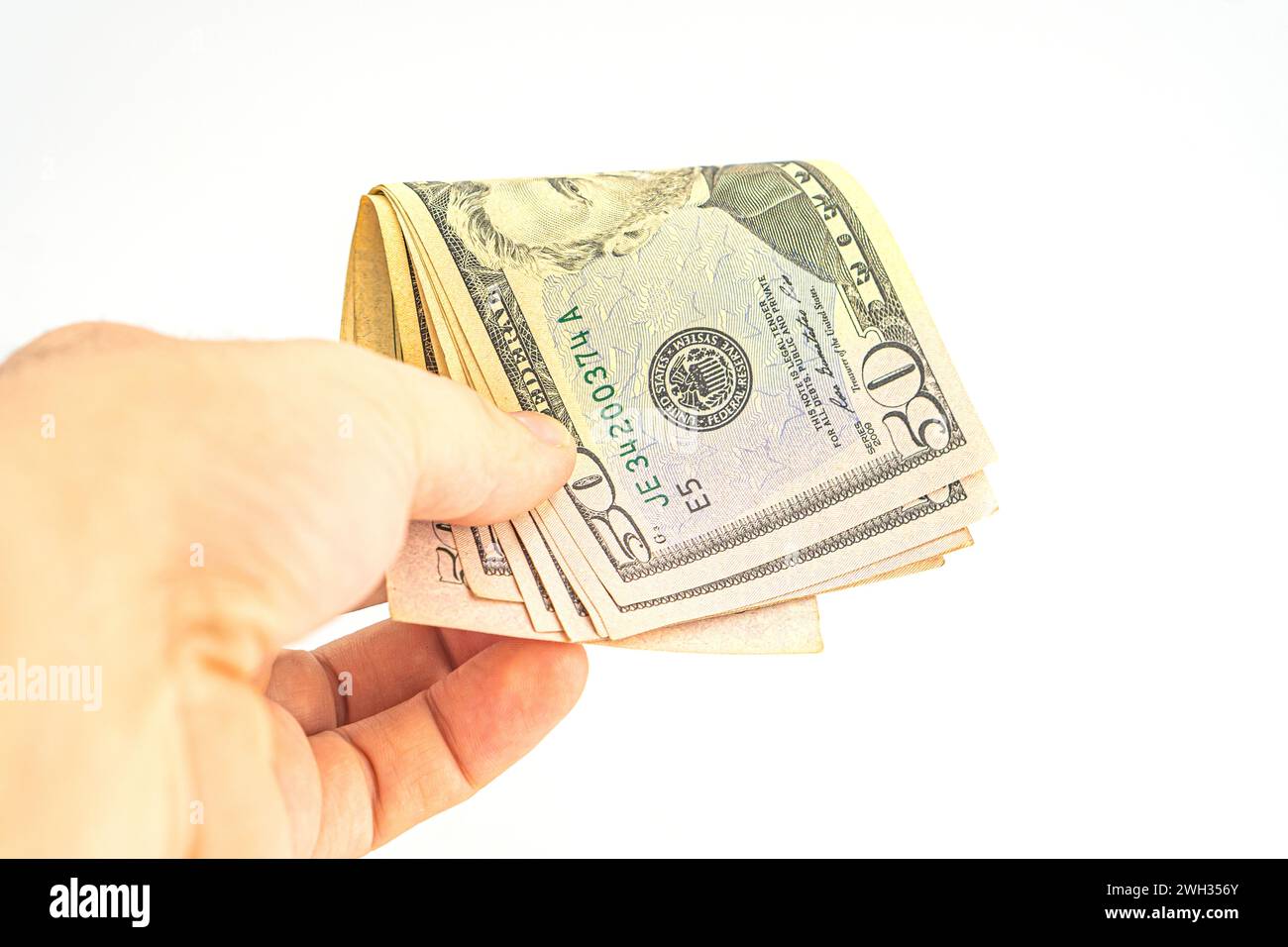 Several 50 dollar bills in hand. Man hand with dollars isolated on a ...