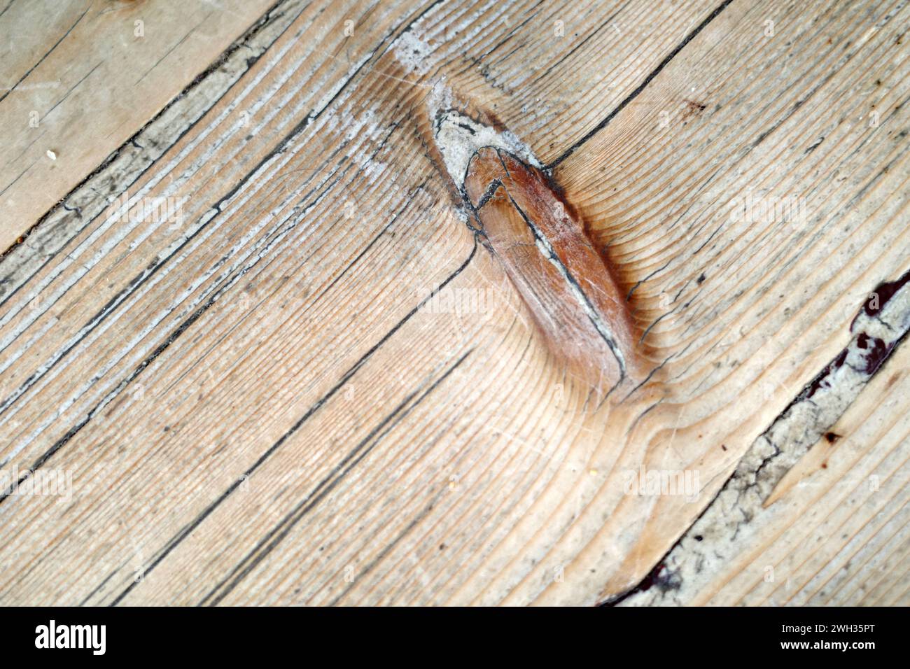 An old, repaired and much used table top with cracks and a knot Stock ...