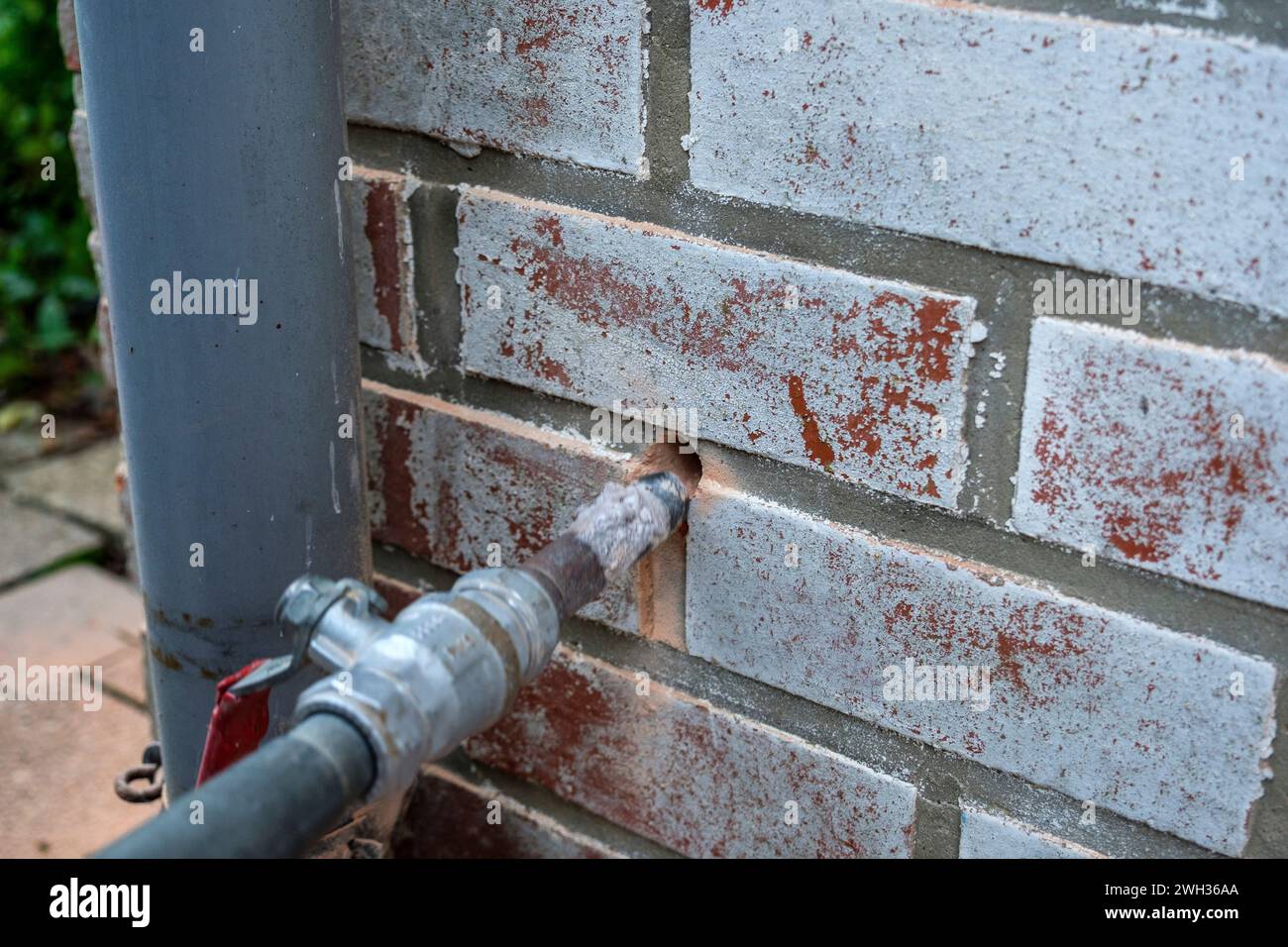 Cavity wall insulation by insufflation between bricks and blocks in the ...