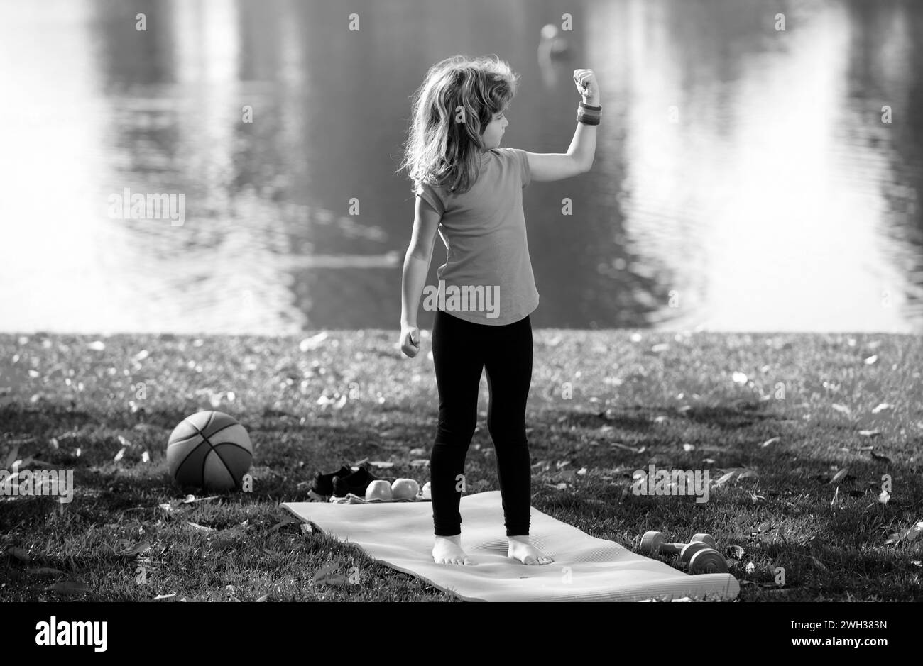 Sport children. Child with strong biceps muscles. Sport exercise for kids. Sporty children ...