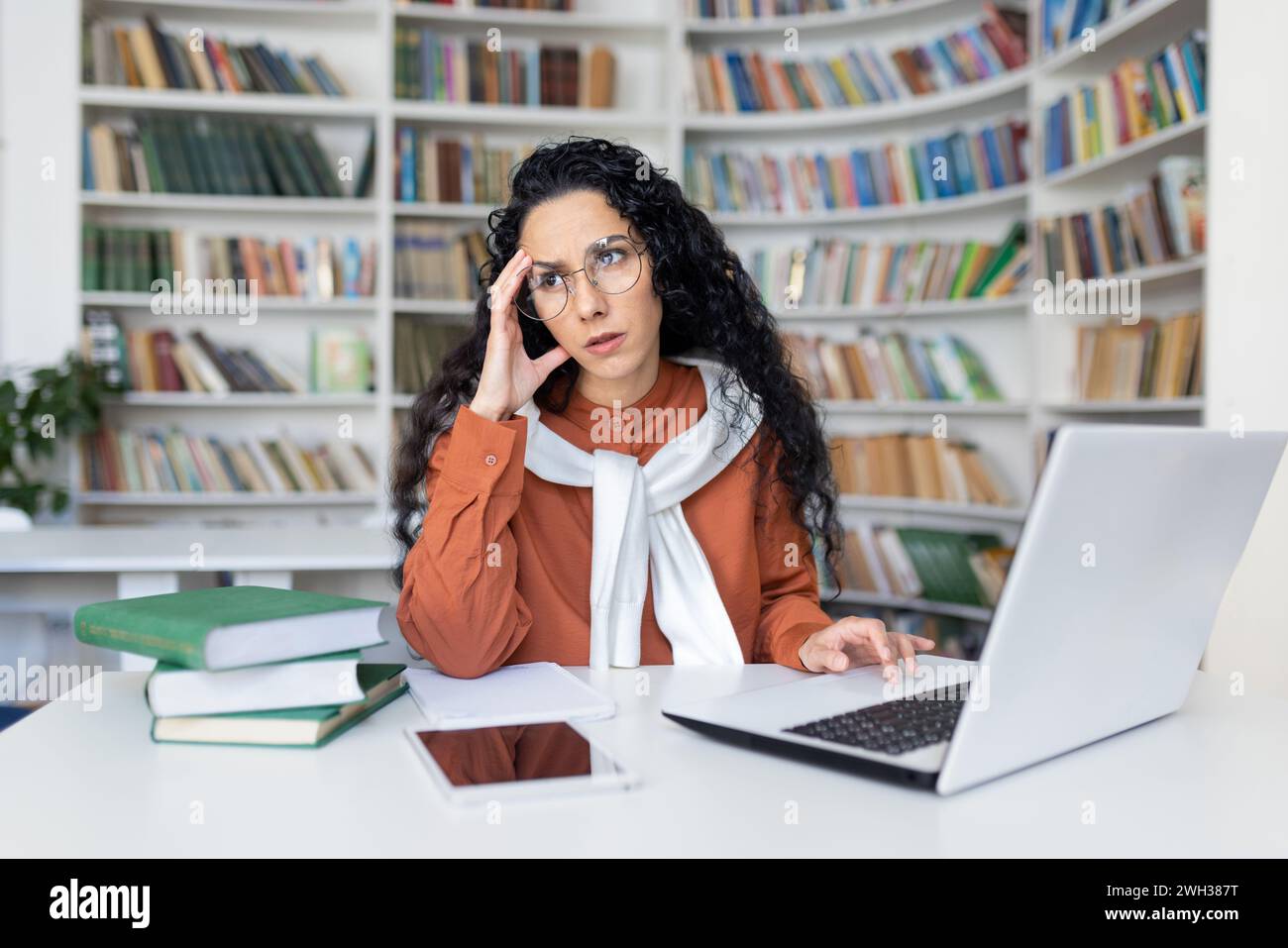 Irritated public library worker rolling eyes and leaning head on hand ...