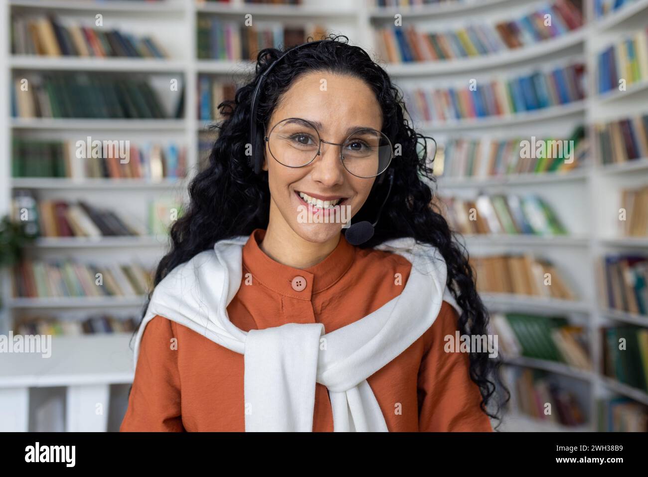 Portrait of attractive young woman with curly hair wearing eyeglasses and casual outfit on ...