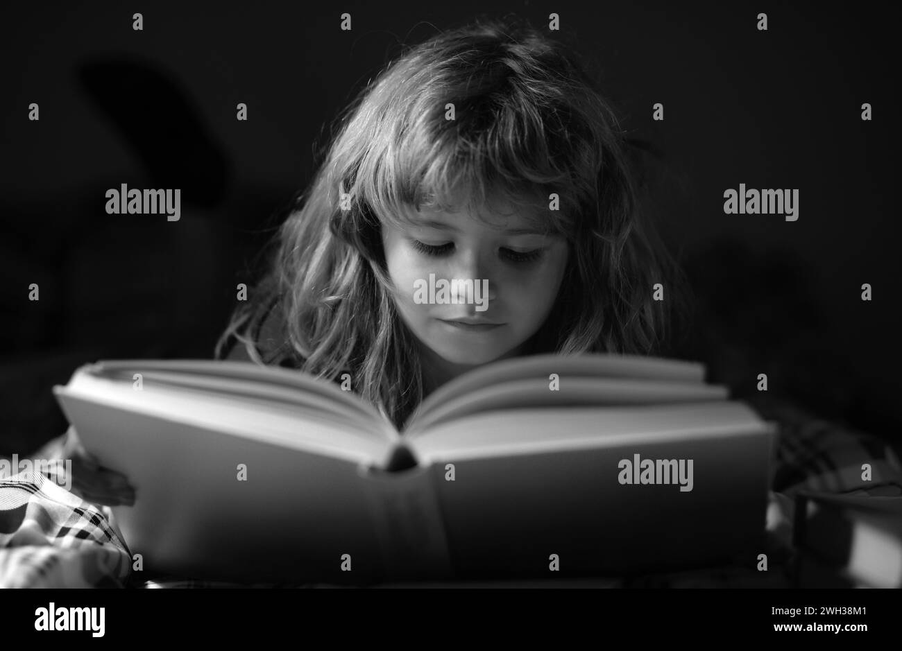 Cute little boy reading book. Child with open book. Homeschool lesson ...