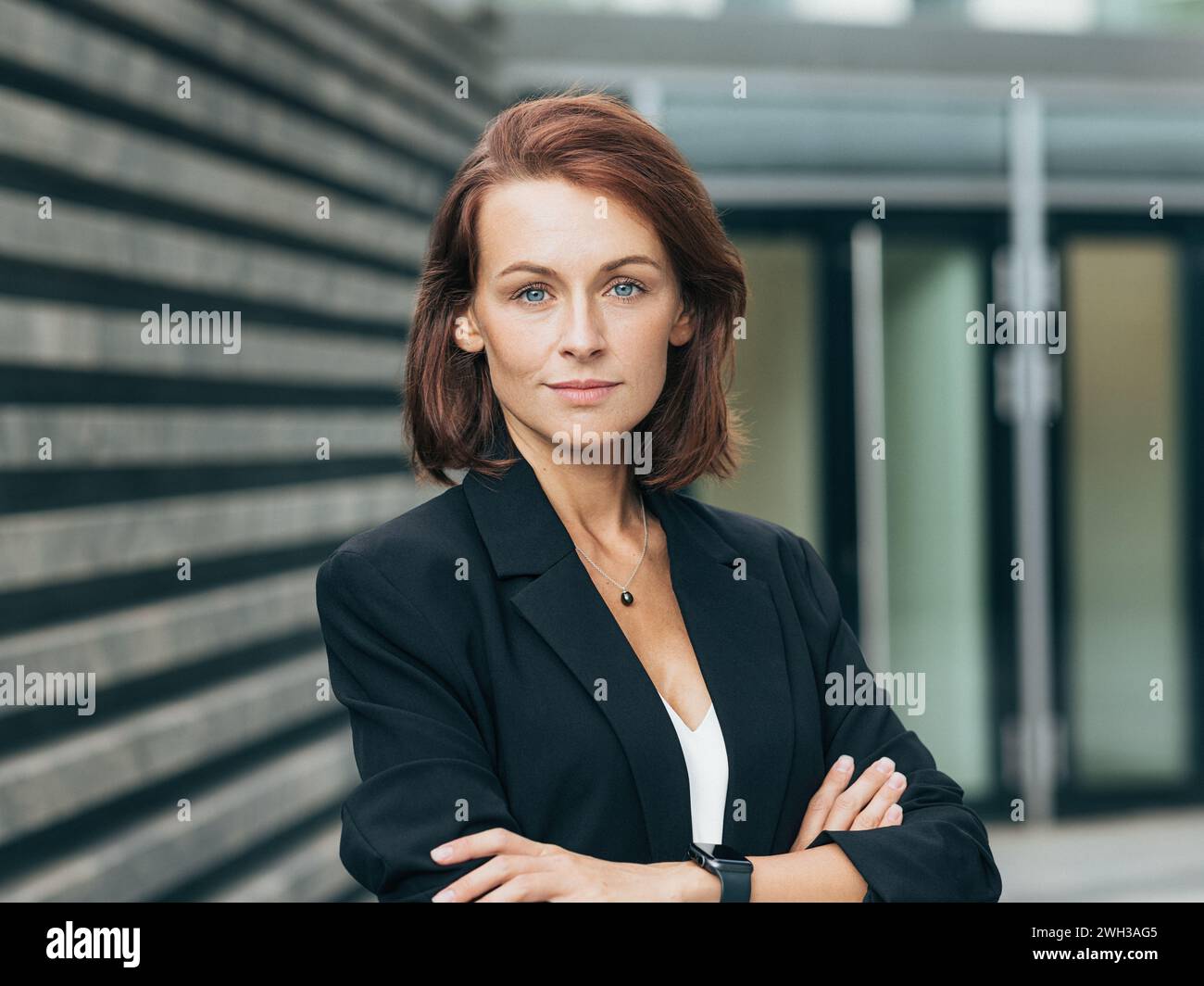 Portrait of a middle-aged female with crossed hands. Businesswoman in ...