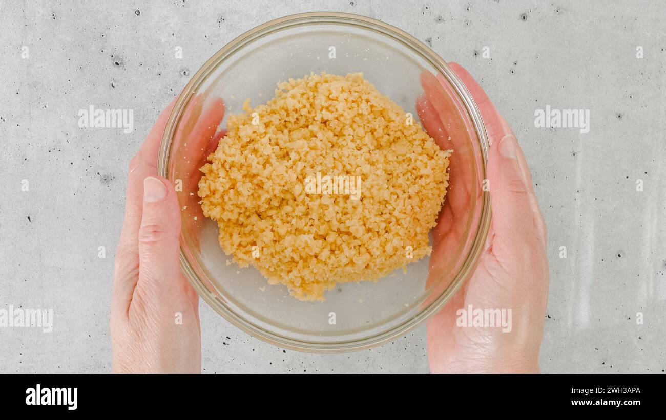 Cracker crust for cheesecake recipe. Mixing crushed crackers with ...