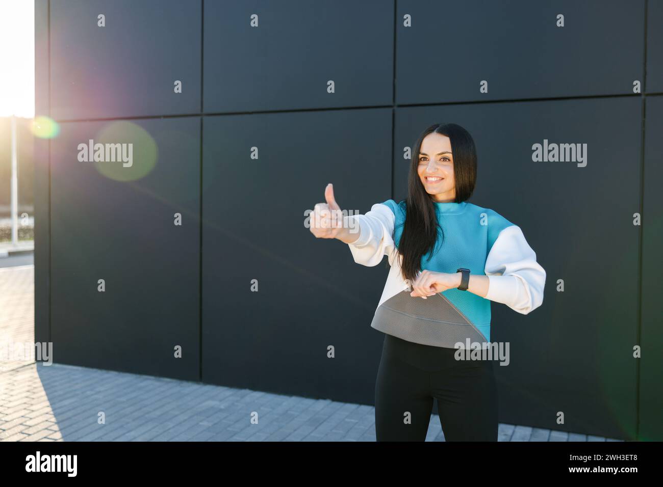 Cute sporty girl smiling cutely and showing good job gesture while ...
