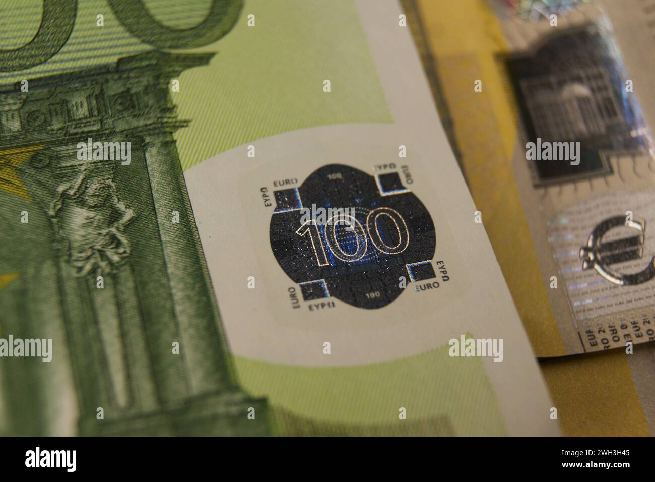 A fragment of a 100 euro banknote with a hologram Stock Photo - Alamy