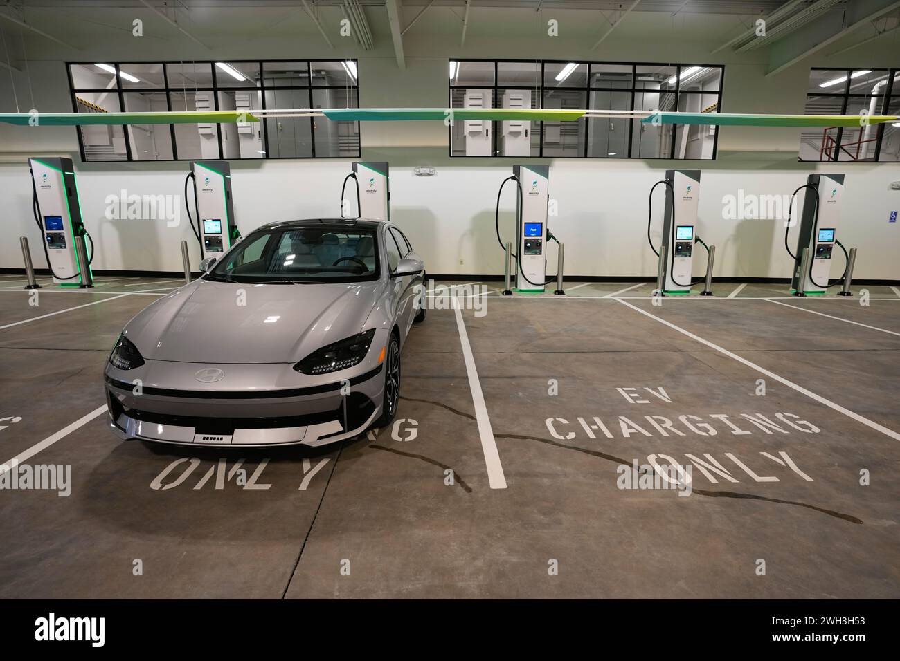Charging bays are seen at the new Electrify America indoor electric ...