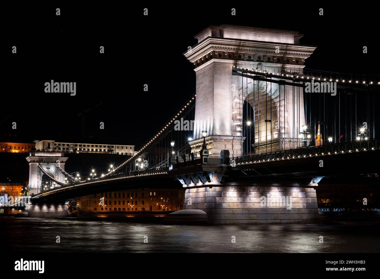 The historic Chain Bridge illuminated at night in Budapest Stock Photo ...