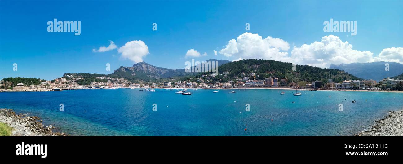 Panoramic View of a Vibrant Coastal Town with Azure Waters and Mountain ...
