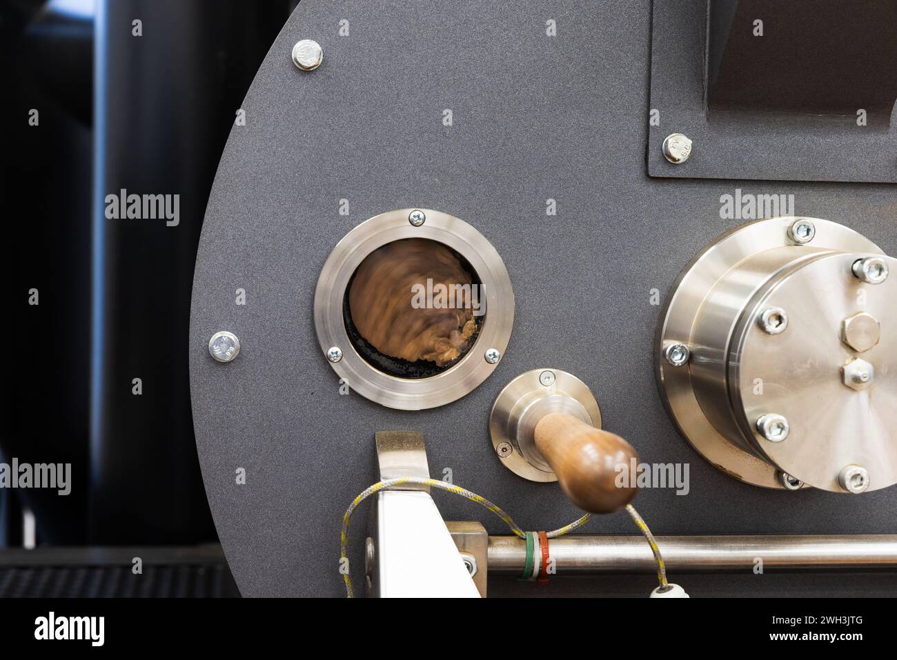 Industrial coffee roaster close-up photo, roasting coffee seeds are ...