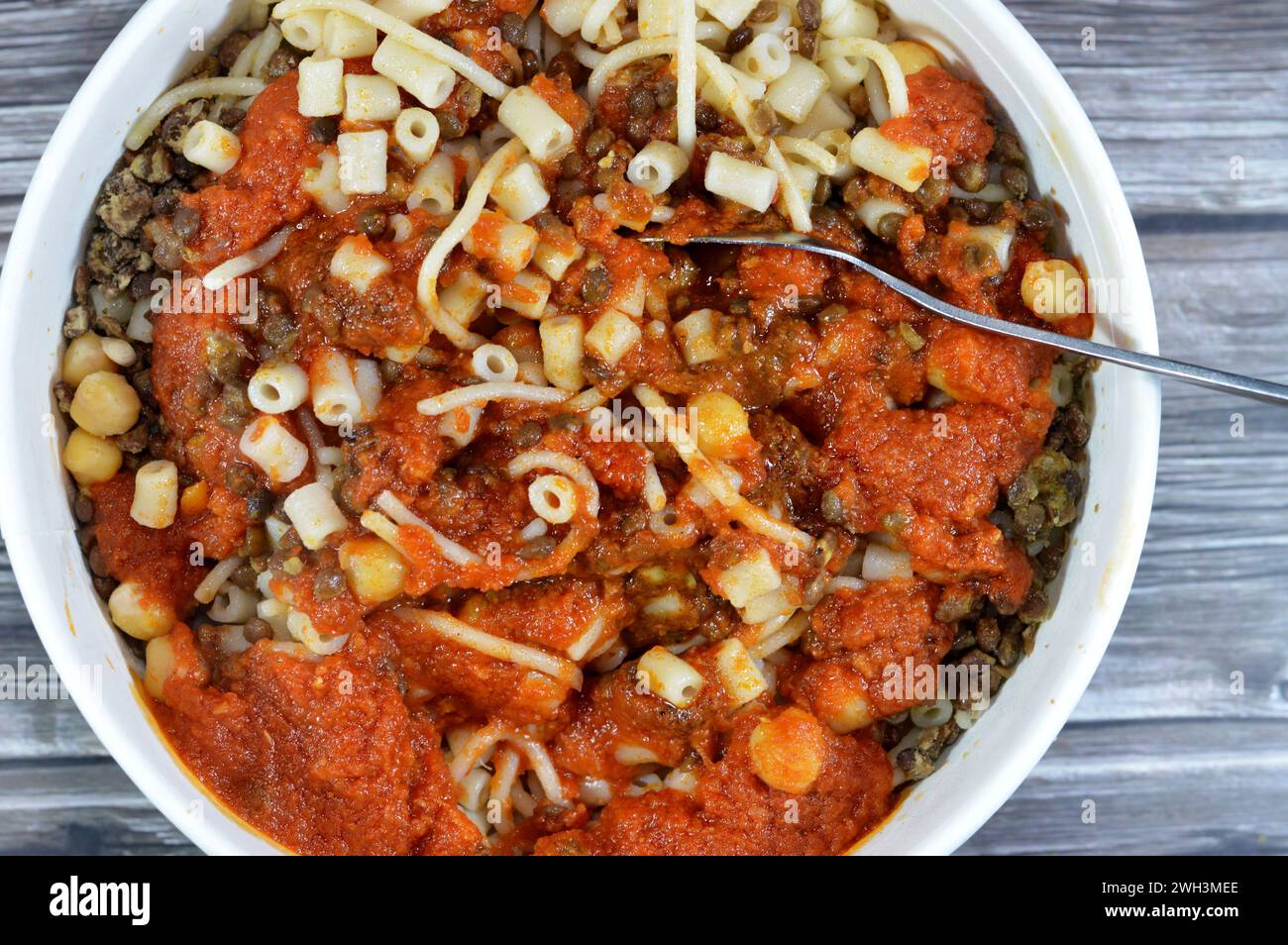 Egyptian cuisine of Koshary, a popular street food made of rice ...